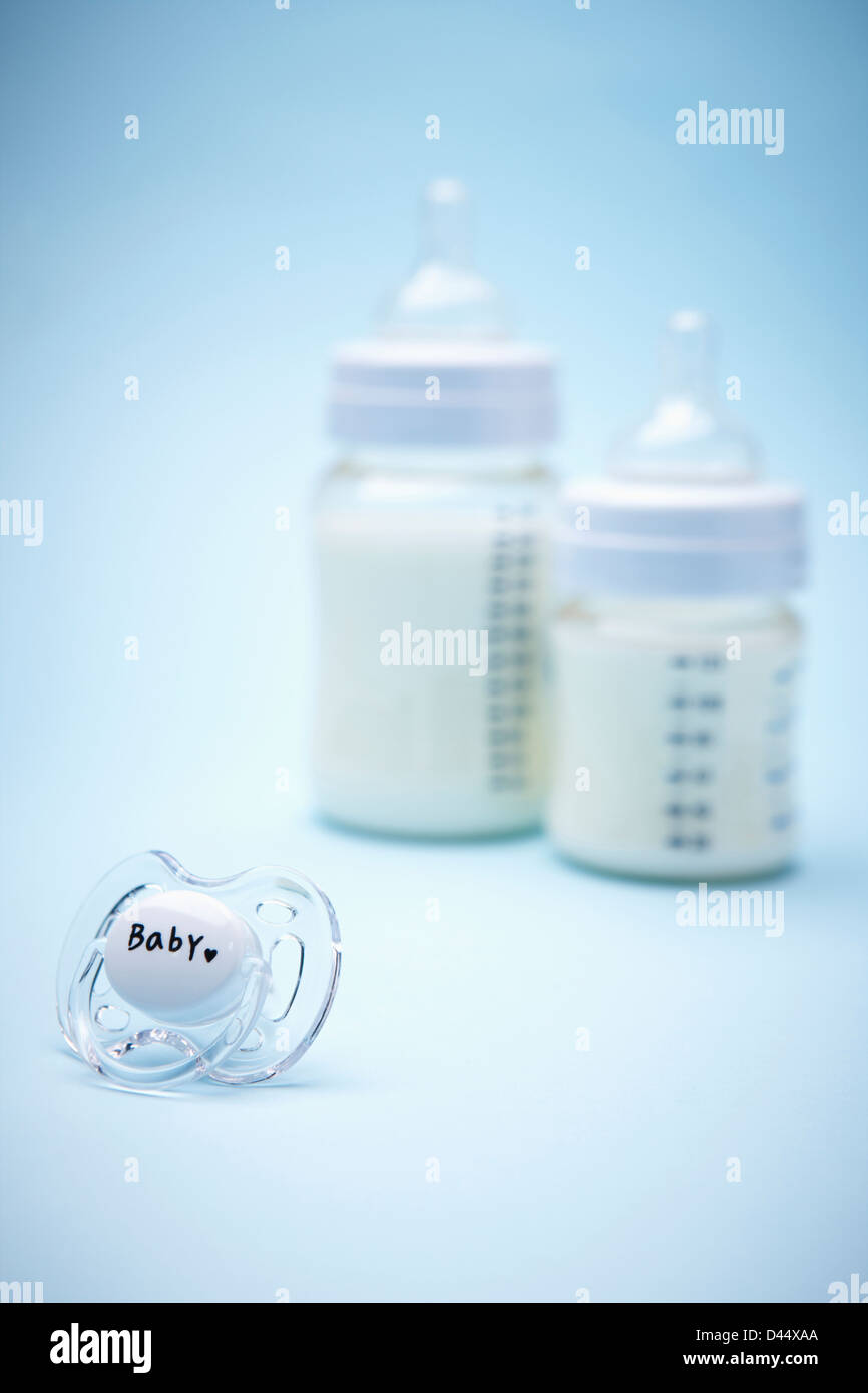 baby's milk bottles and a pacifier Stock Photo - Alamy