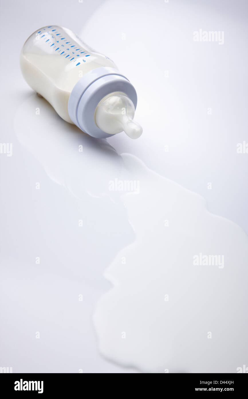 spilt milk on a white background Stock Photo - Alamy