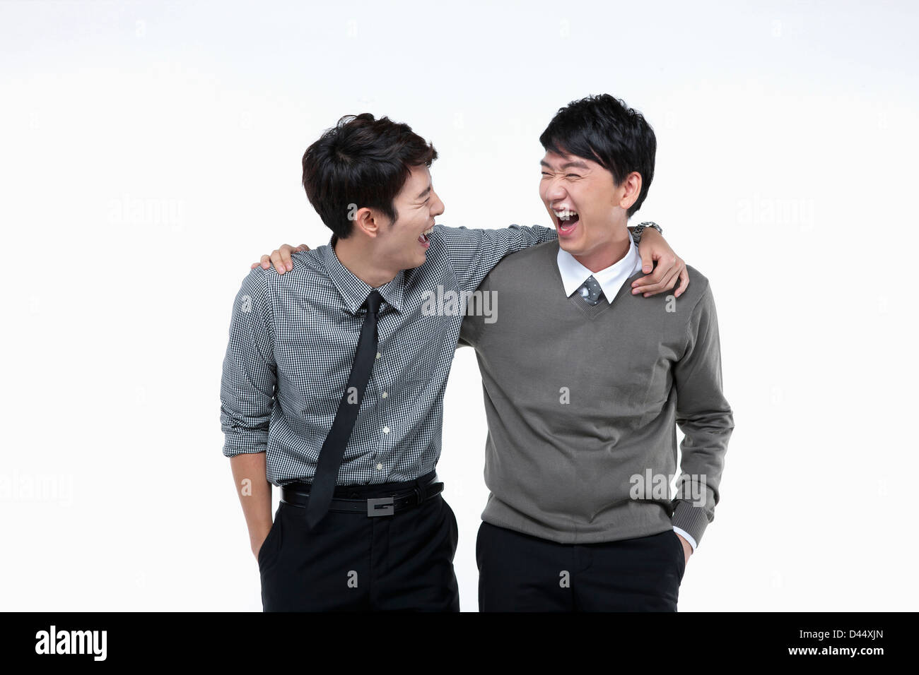 two businessmen smiling with arms across each other Stock Photo - Alamy