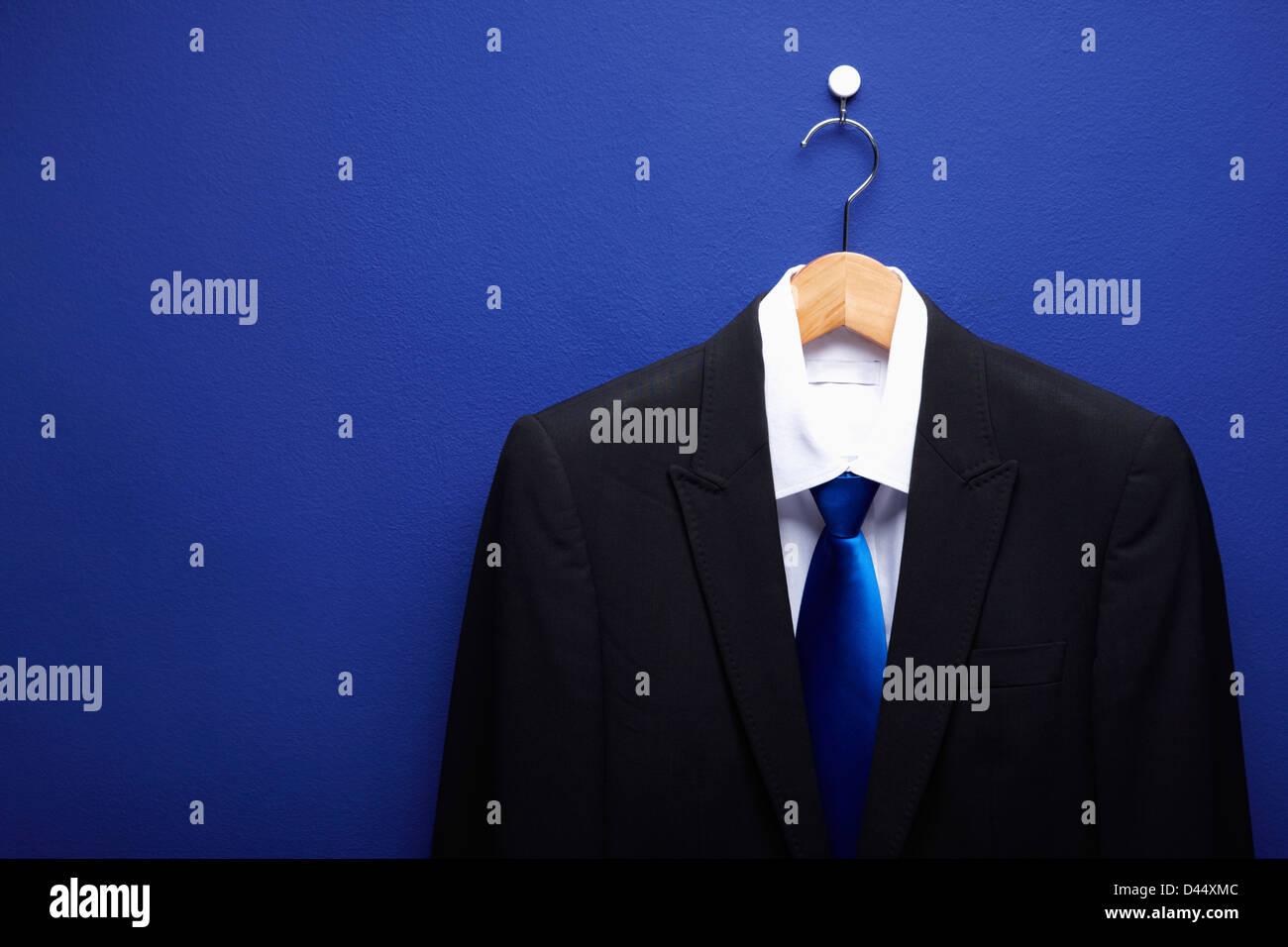 a business suit hanging on a hanger Stock Photo - Alamy