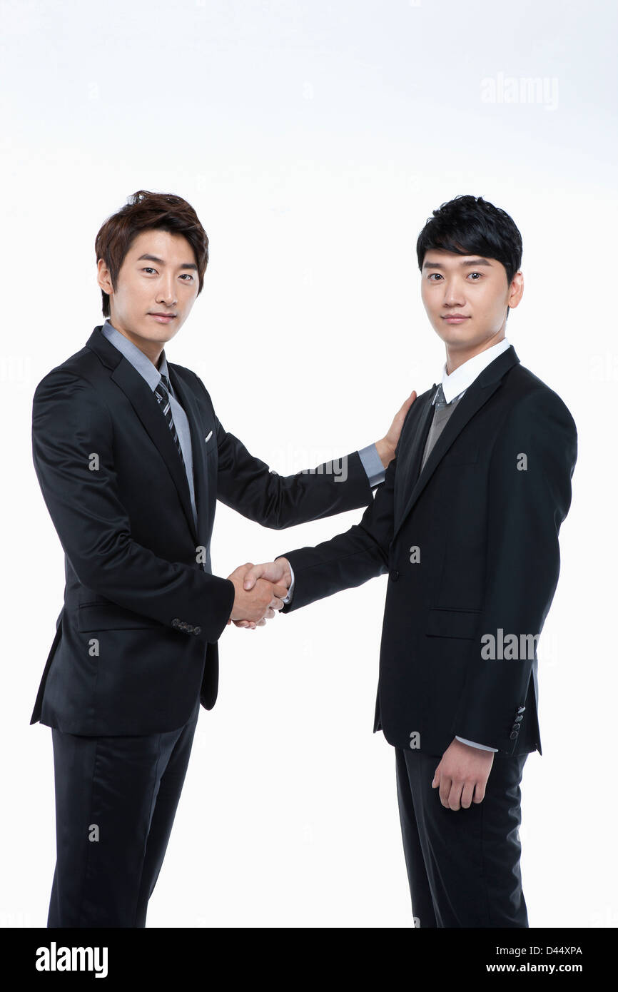 two businessmen shaking hands Stock Photo - Alamy