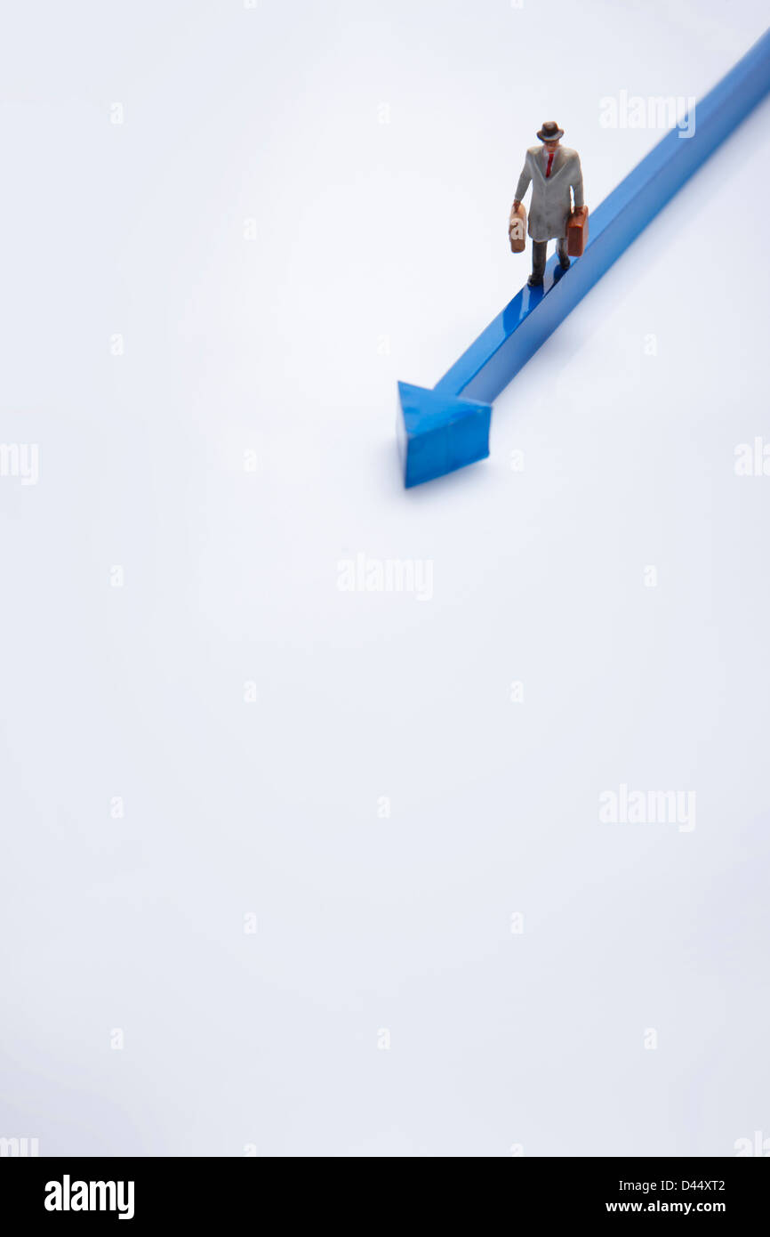 a man walking on a blue arrow Stock Photo - Alamy