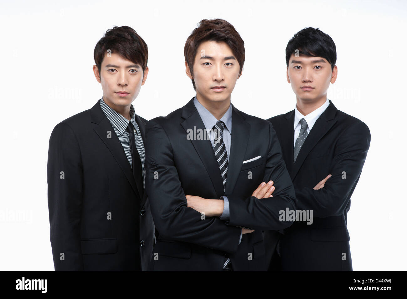 three businessmen standing in a white background Stock Photo - Alamy