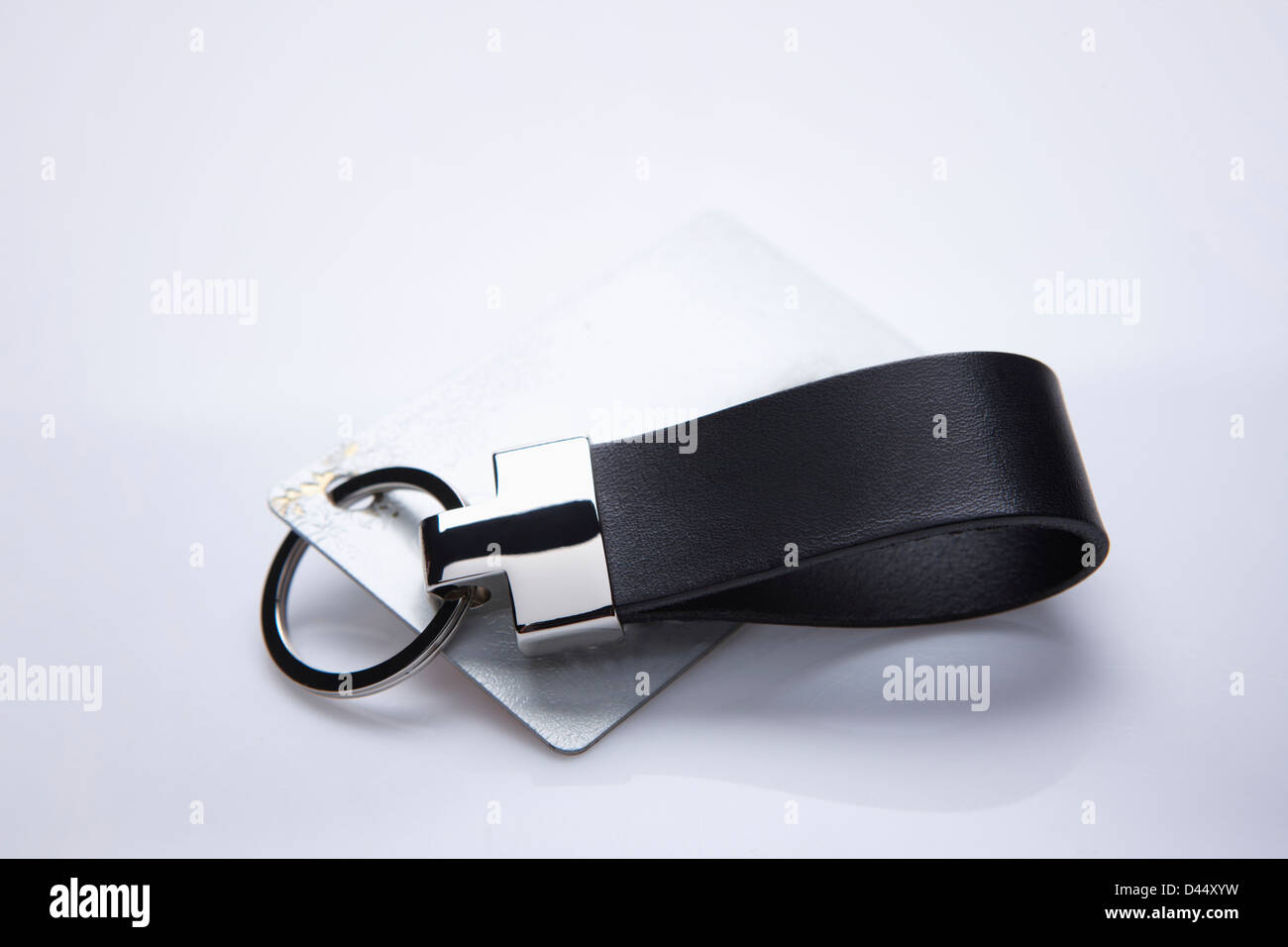 a black key chain in white background Stock Photo - Alamy