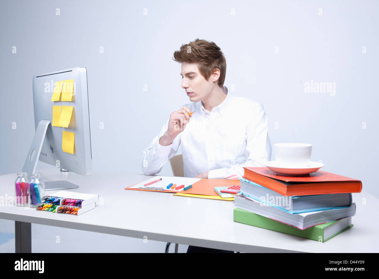 a man on a desk using computer Stock Photo - Alamy