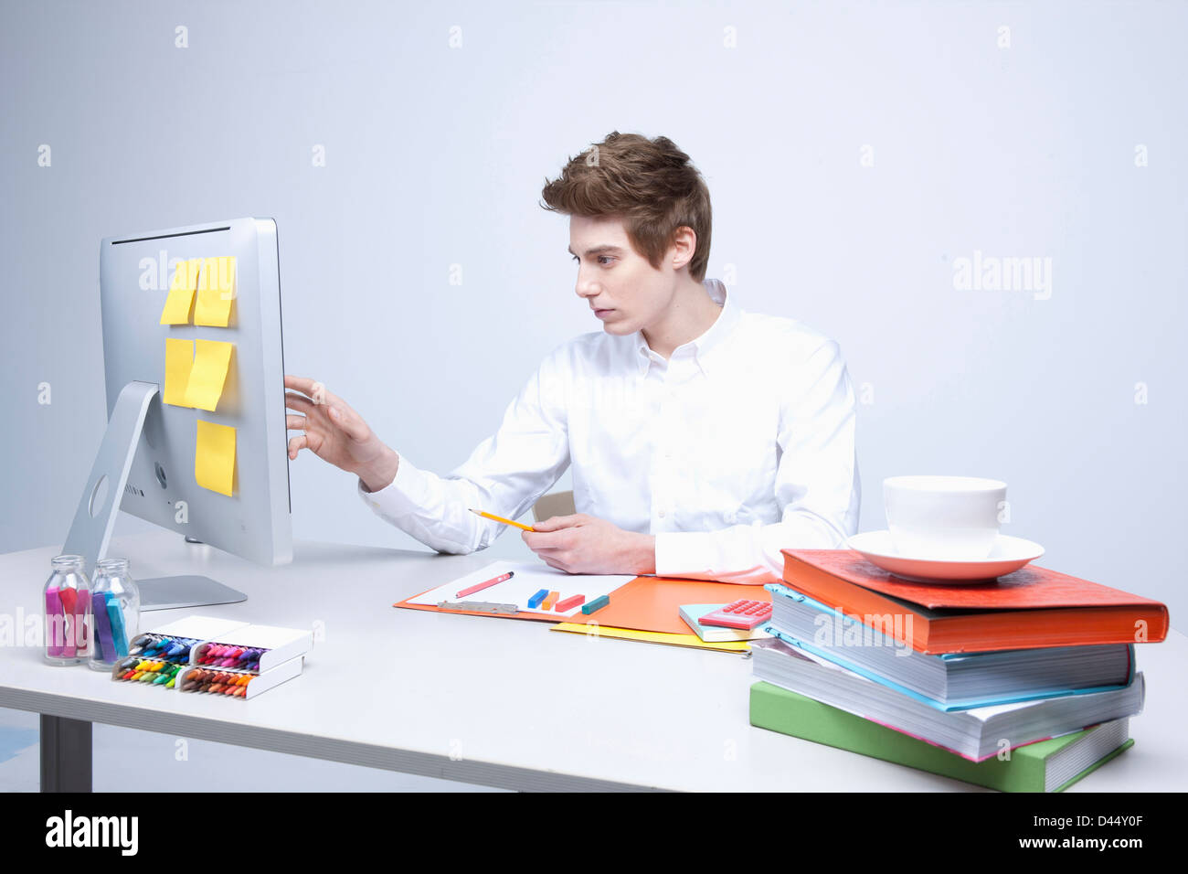 a man on a desk using computer Stock Photo - Alamy