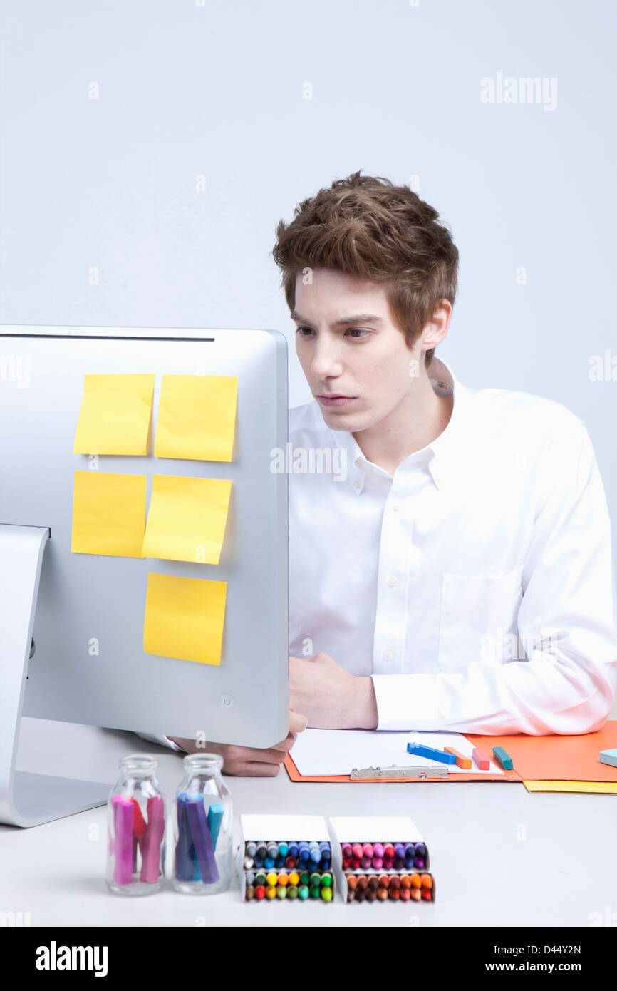 a man on a desk using computer Stock Photo - Alamy