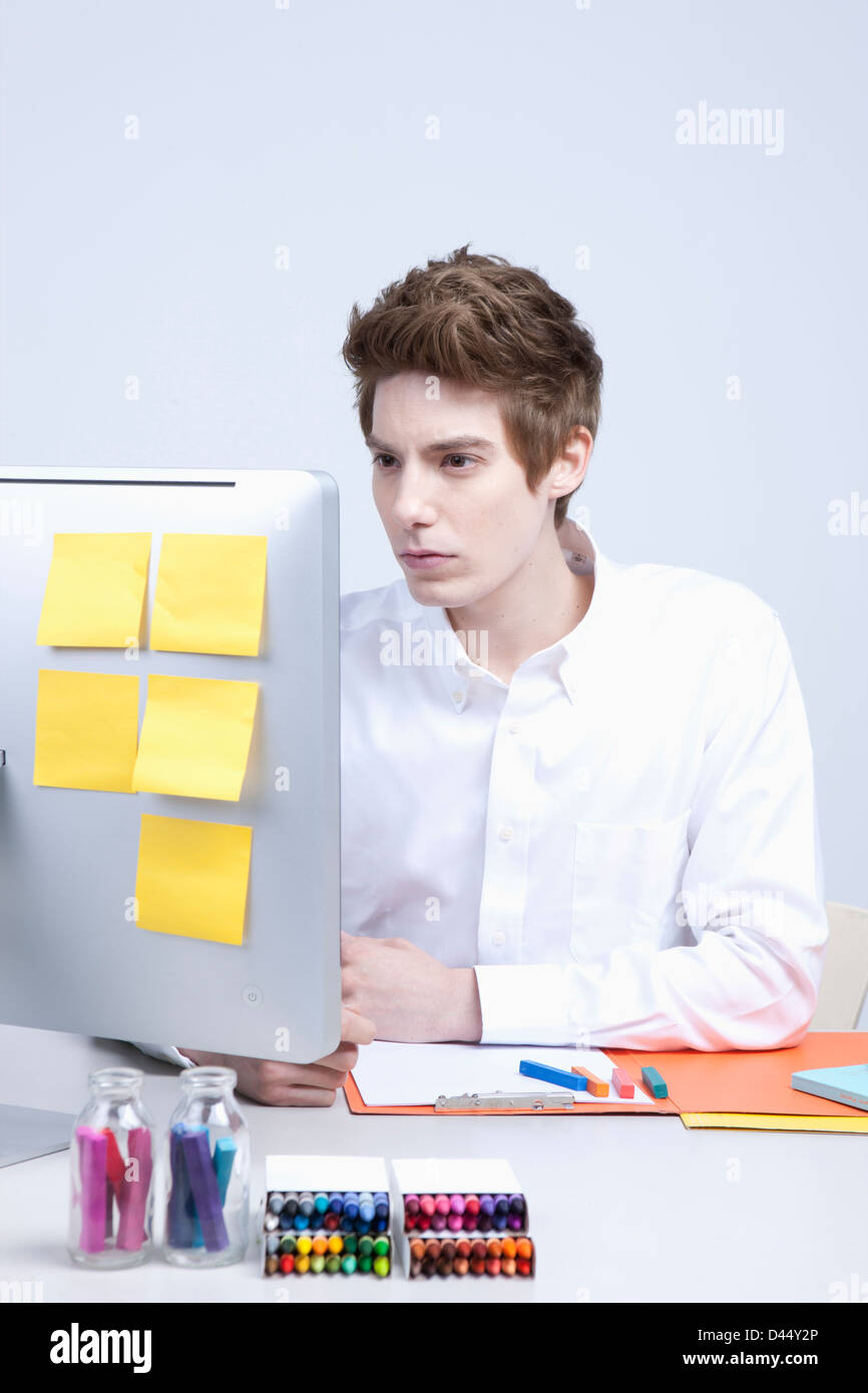 a man on a desk using computer Stock Photo - Alamy