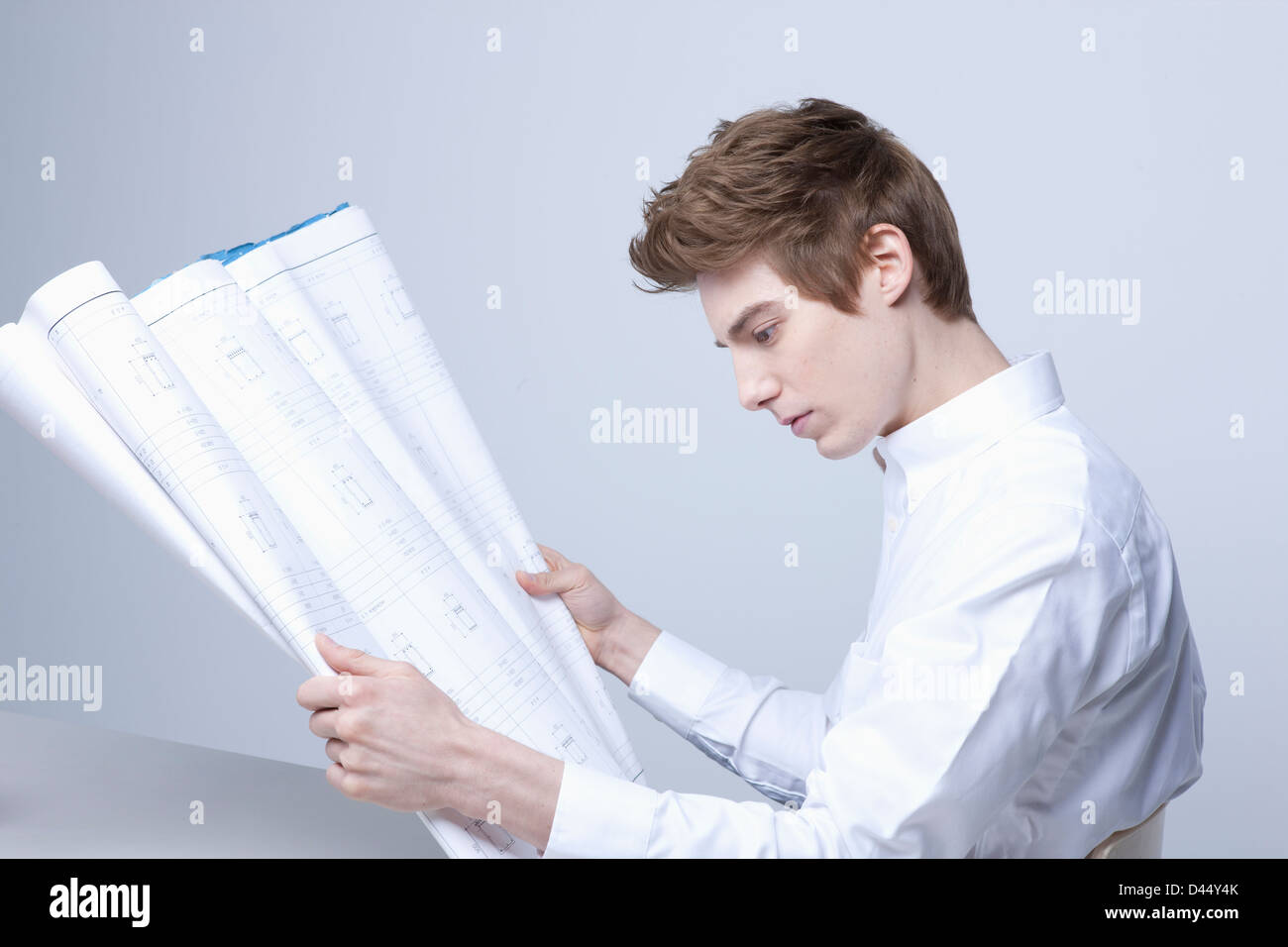 a man in white shirt reading Stock Photo - Alamy