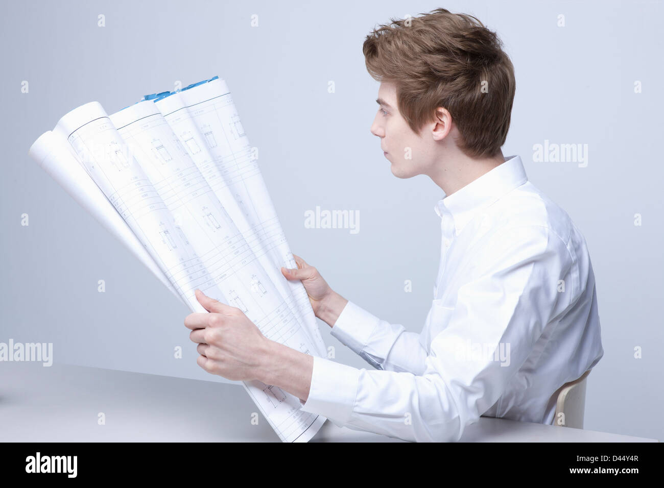 a man in white shirt reading Stock Photo - Alamy