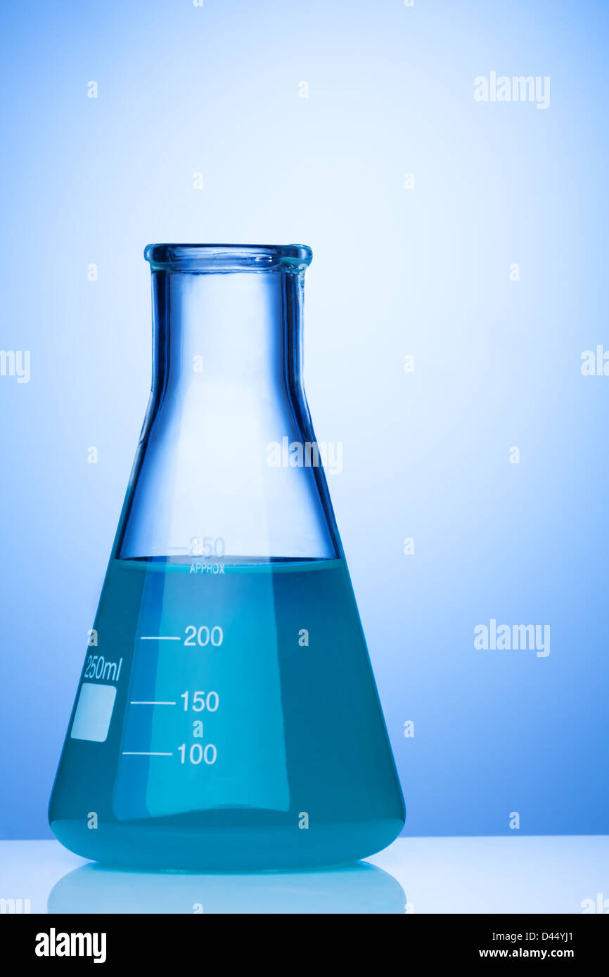 Big laboratory flask with blue liquid Stock Photo - Alamy