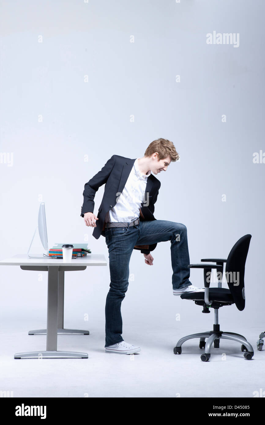 Man stepping on chair hi-res stock photography and images - Alamy