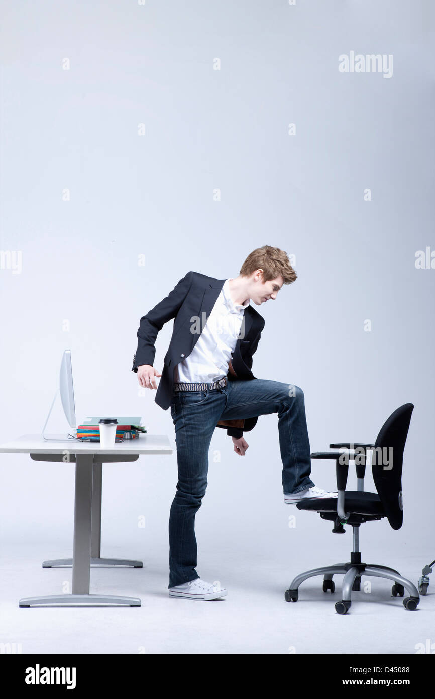 a man stepping on a chair Stock Photo - Alamy