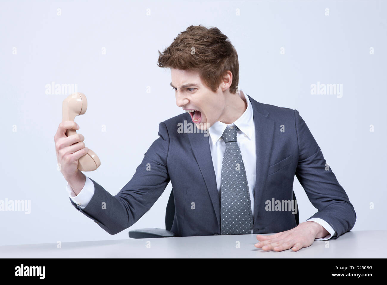 a man shouting at a phone Stock Photo - Alamy