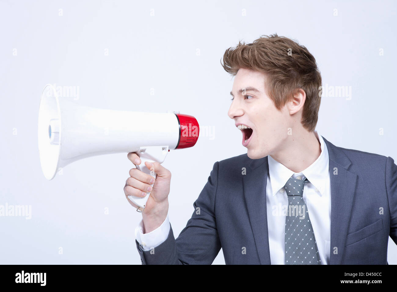a man shouting through a megaphone Stock Photo - Alamy