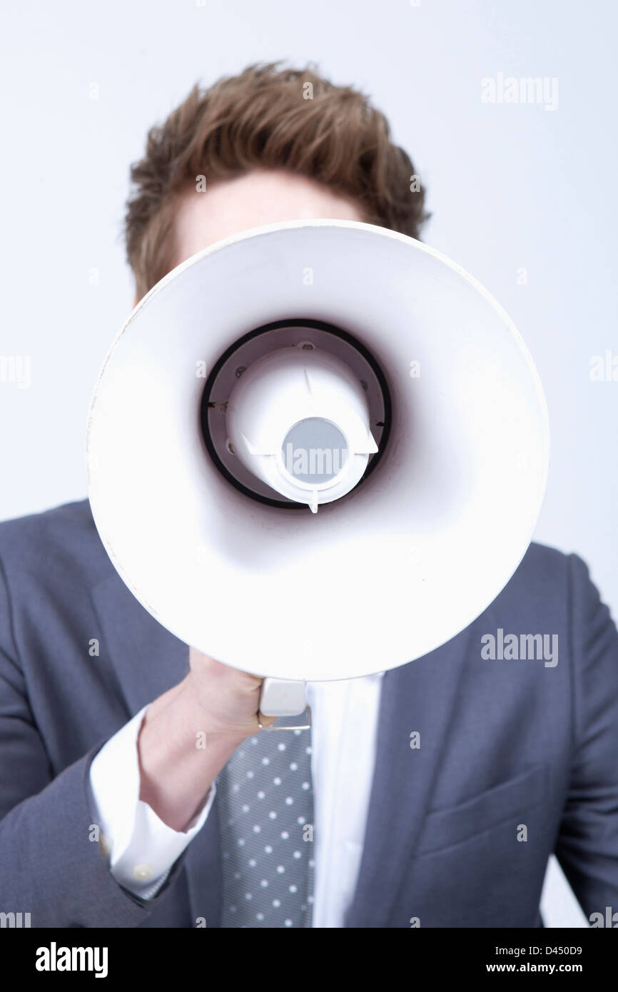 a man shouting through a megaphone Stock Photo - Alamy