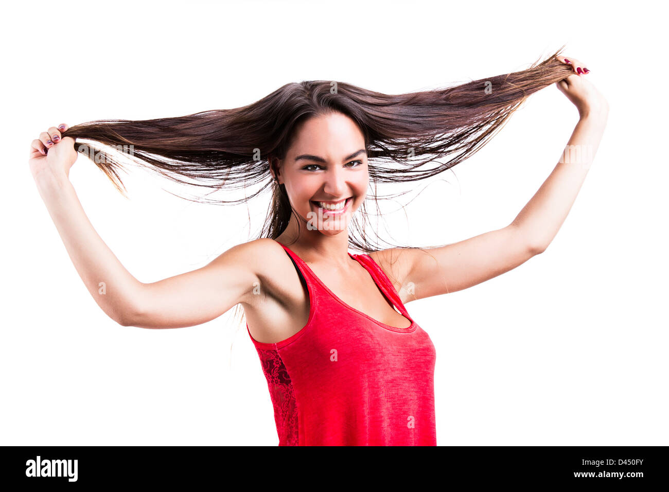 Beautiful young woman grabbing her own hair, isolated over white ...