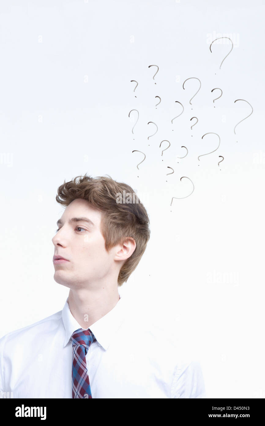 a western businessman with question marks Stock Photo - Alamy