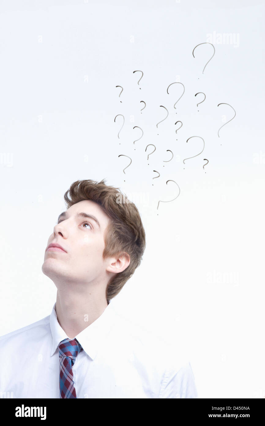 a western businessman with question marks Stock Photo - Alamy