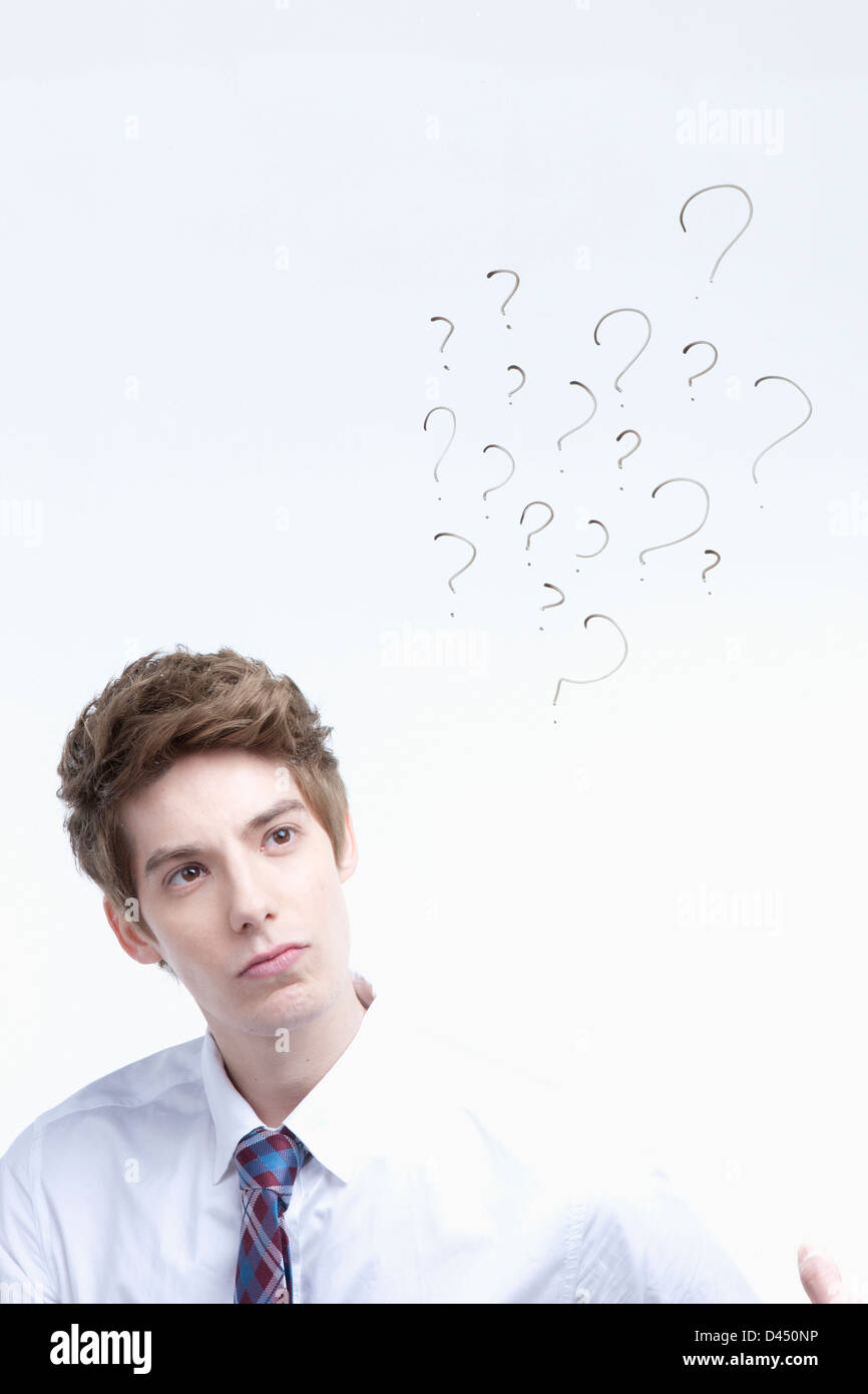 a western businessman with question marks Stock Photo - Alamy