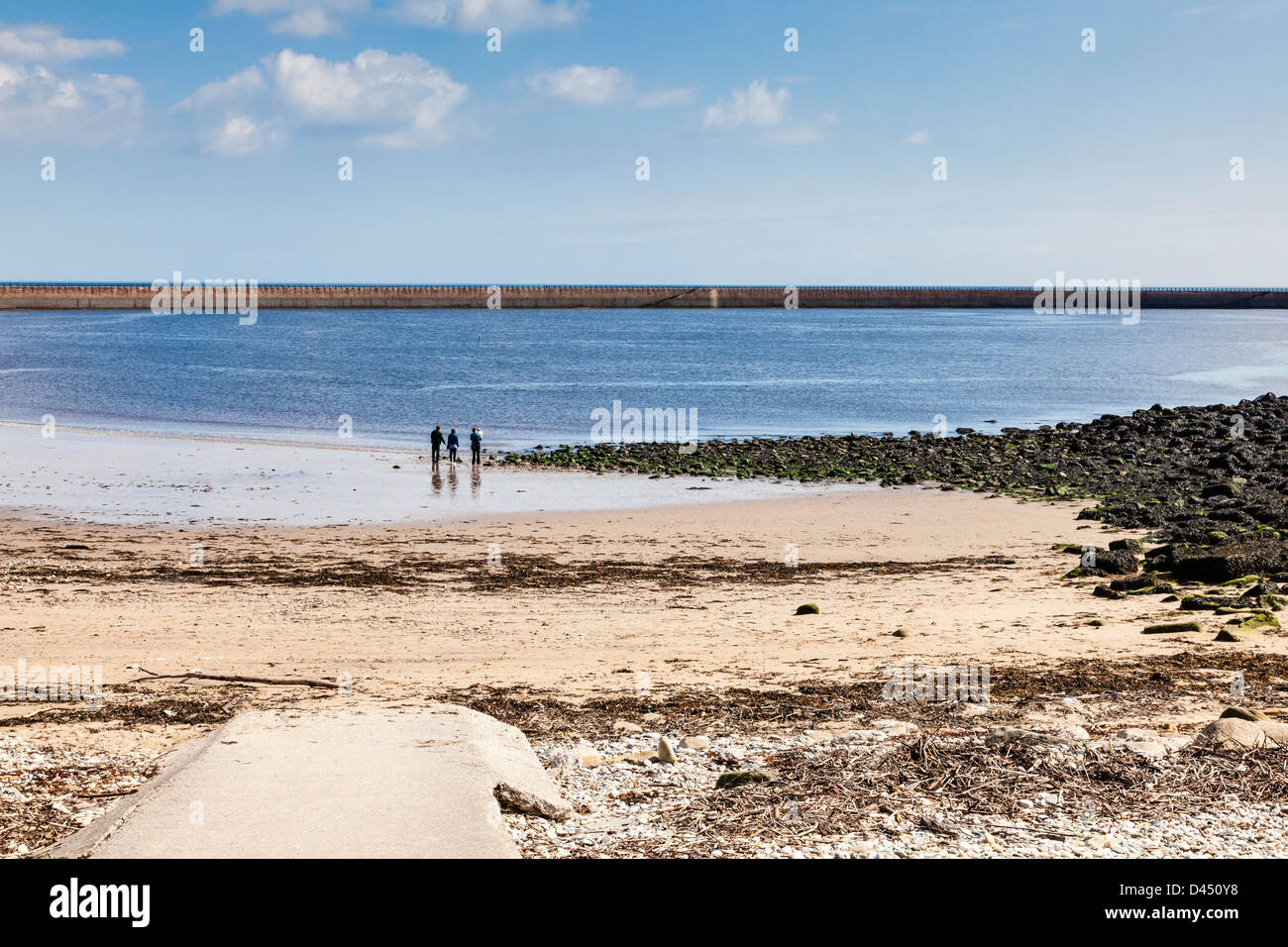 Roker Seafront, with a family with a baby looking at the Pier ...