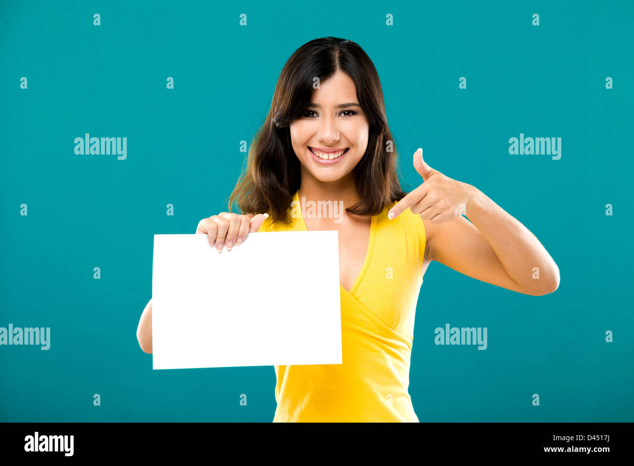 Beautiful Asian woman holding and pointing to a blue billboard, over a ...