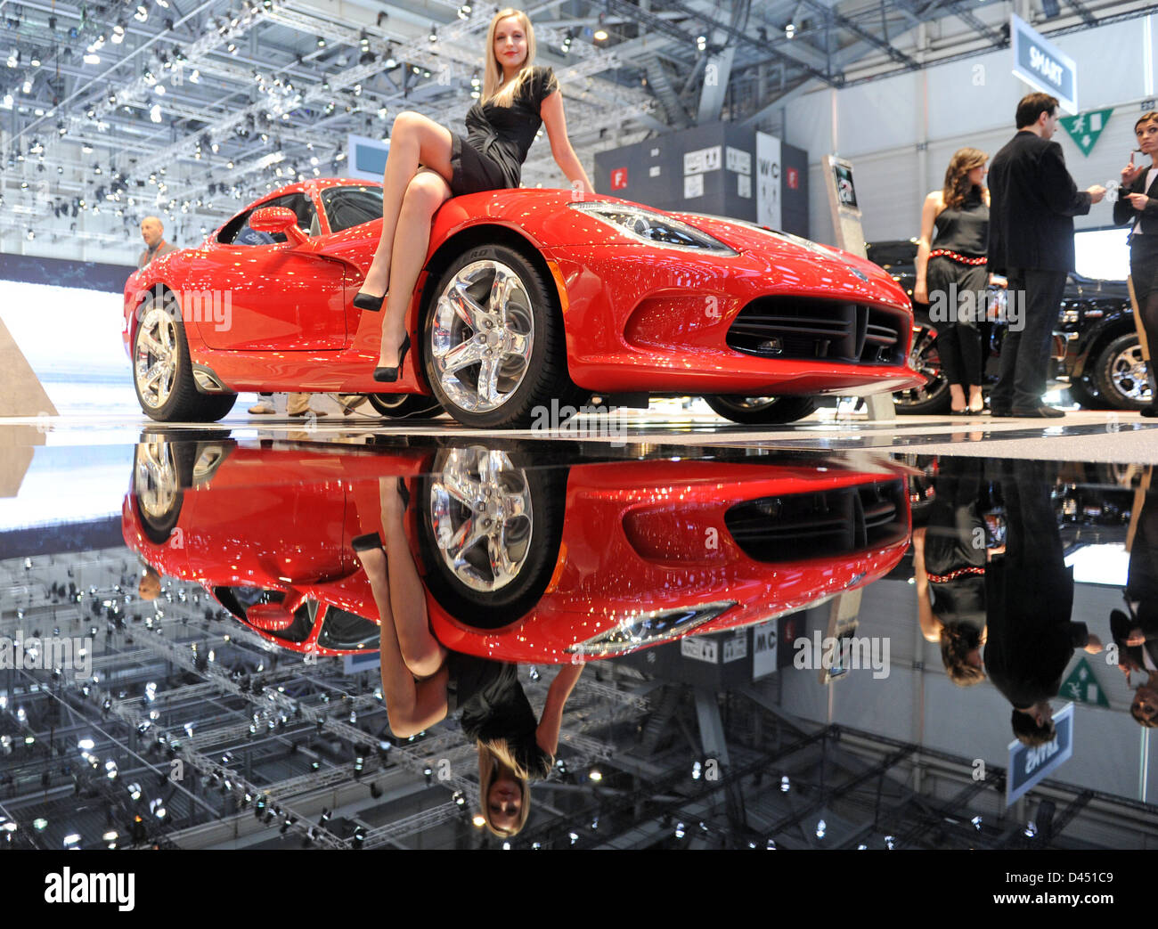 Geneva, Switzerland. 5th March 2013. A model sits on the hood of a SRT ...