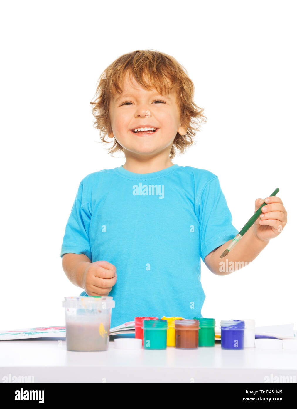 Happy smiling kid painting with paintbrush and colorful vivid colors ...