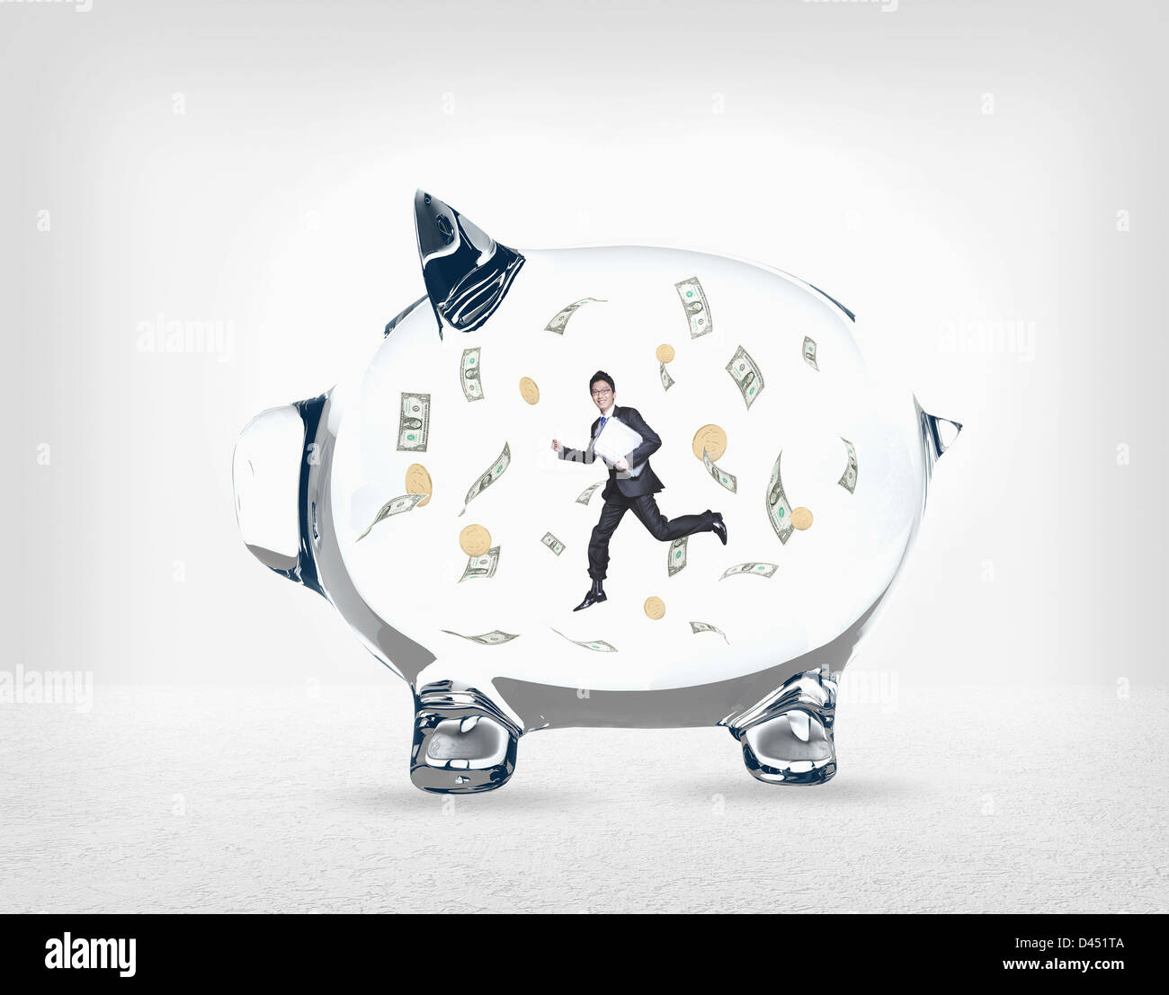 businessman running inside a piggy bank Stock Photo - Alamy