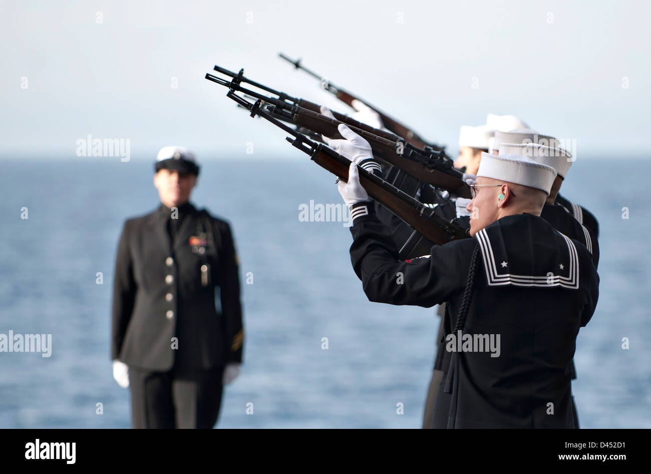 US Navy honor guard render a gun salute during a burial at sea for 20 ...