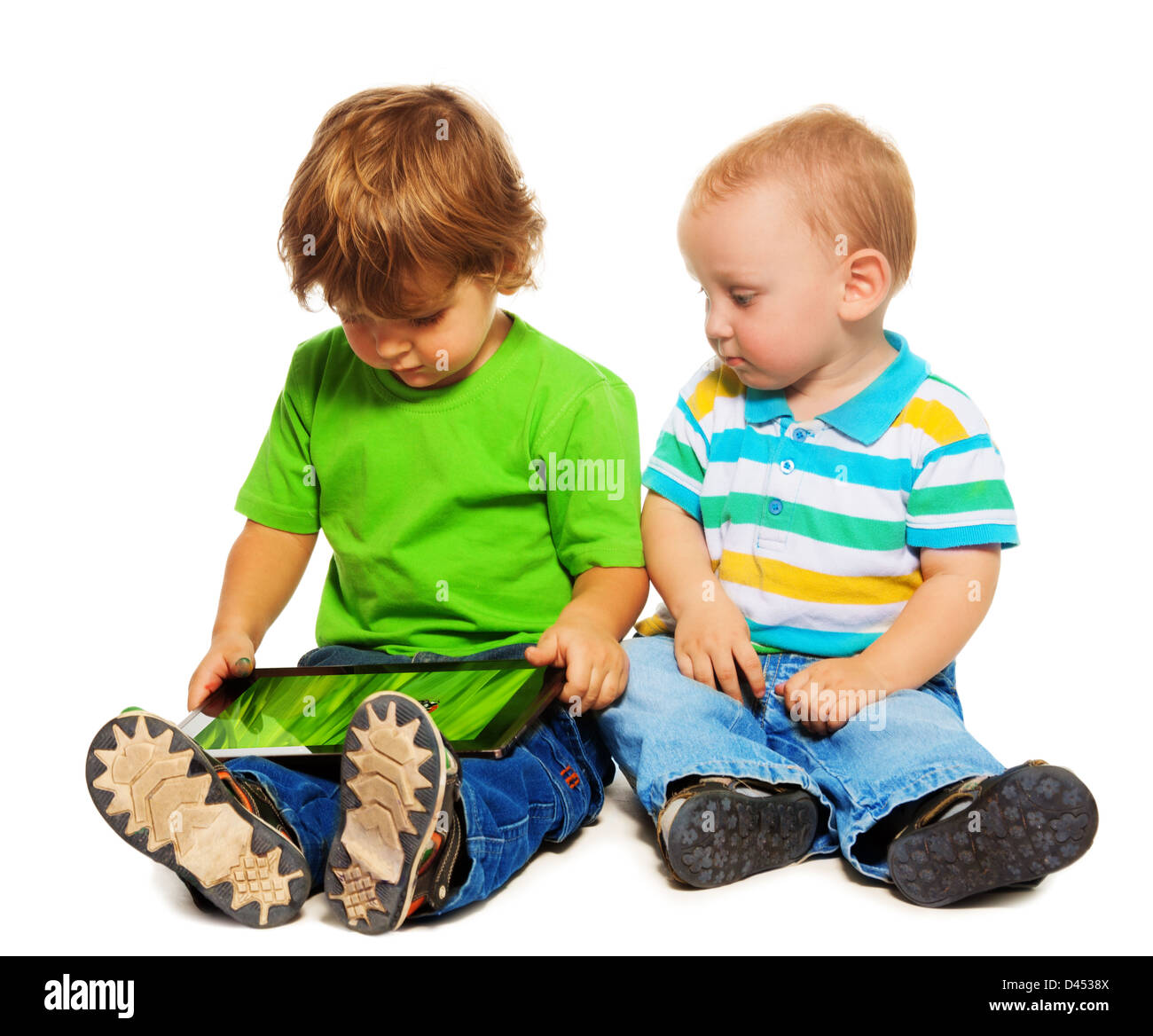 Two kids - little two years old playing with tablet computer Stock ...