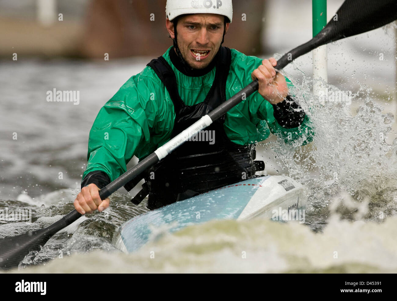 Man paddling canoe in whitewater rapids competition Stock Photo - Alamy
