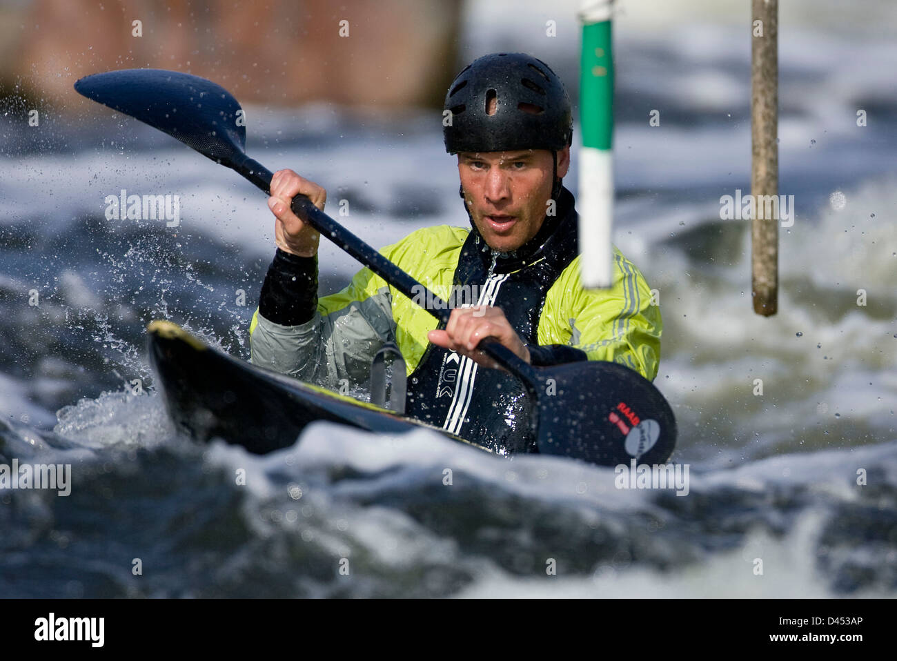 Man paddling canoe round sporting posts in river competition Stock ...