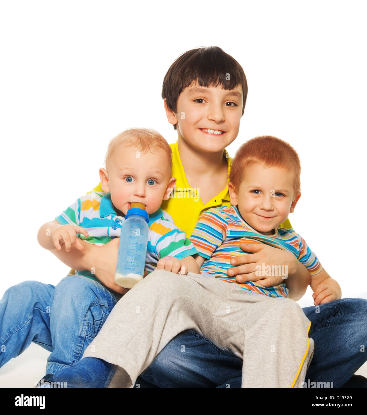 Big brother sitting with his two siblings Stock Photo - Alamy