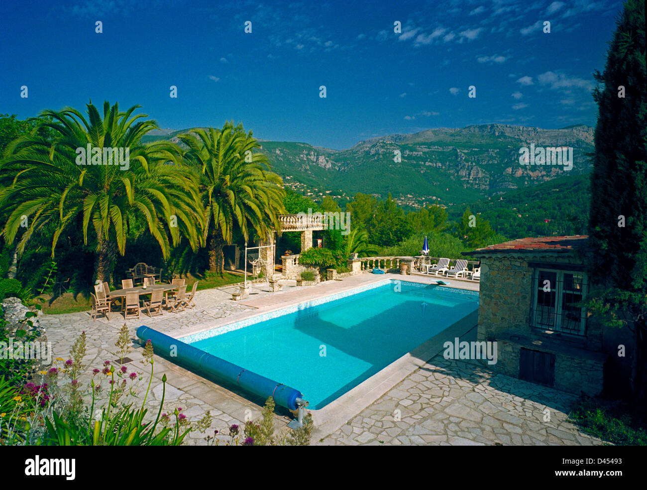 The garden of a large country house complete with swimming pool in the ...