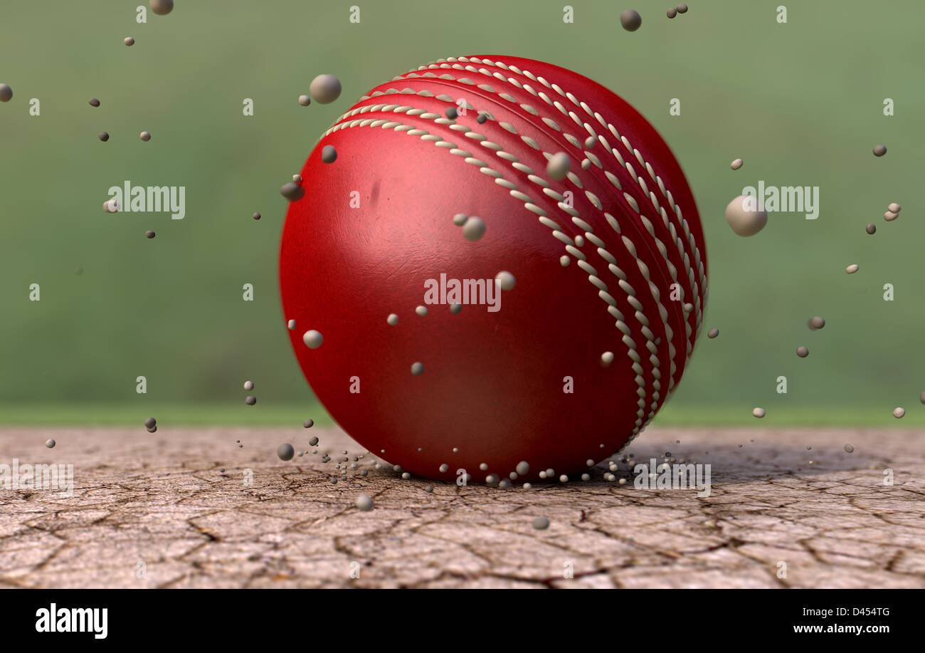 A red leather stitched cricket ball hitting a cracked cricket pitch ...