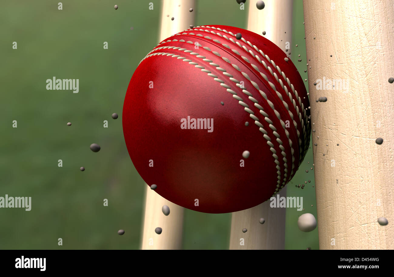A red leather stitched cricket ball hitting wooden wickets with dirt ...