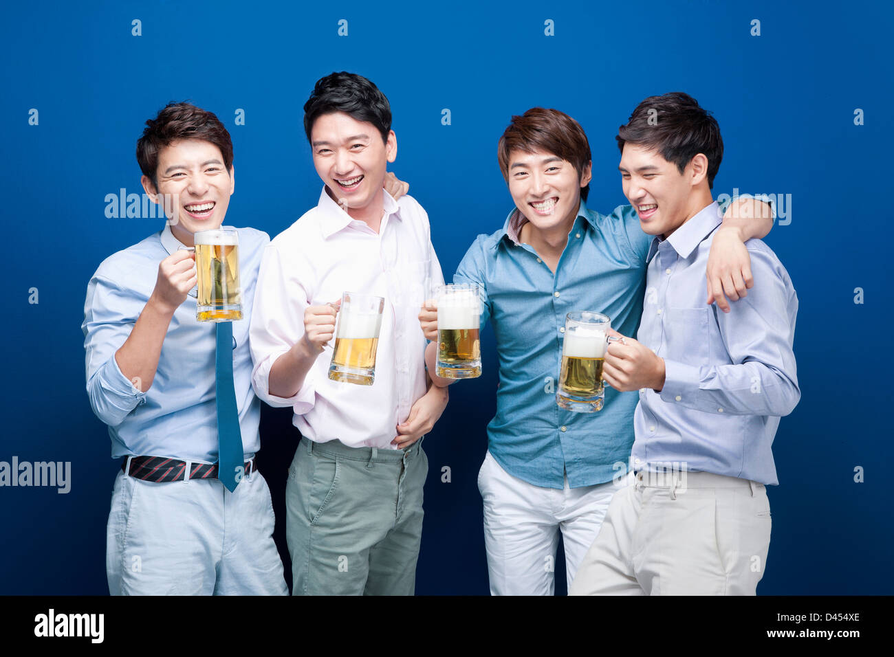 businessmen posing while holding beer Stock Photo - Alamy