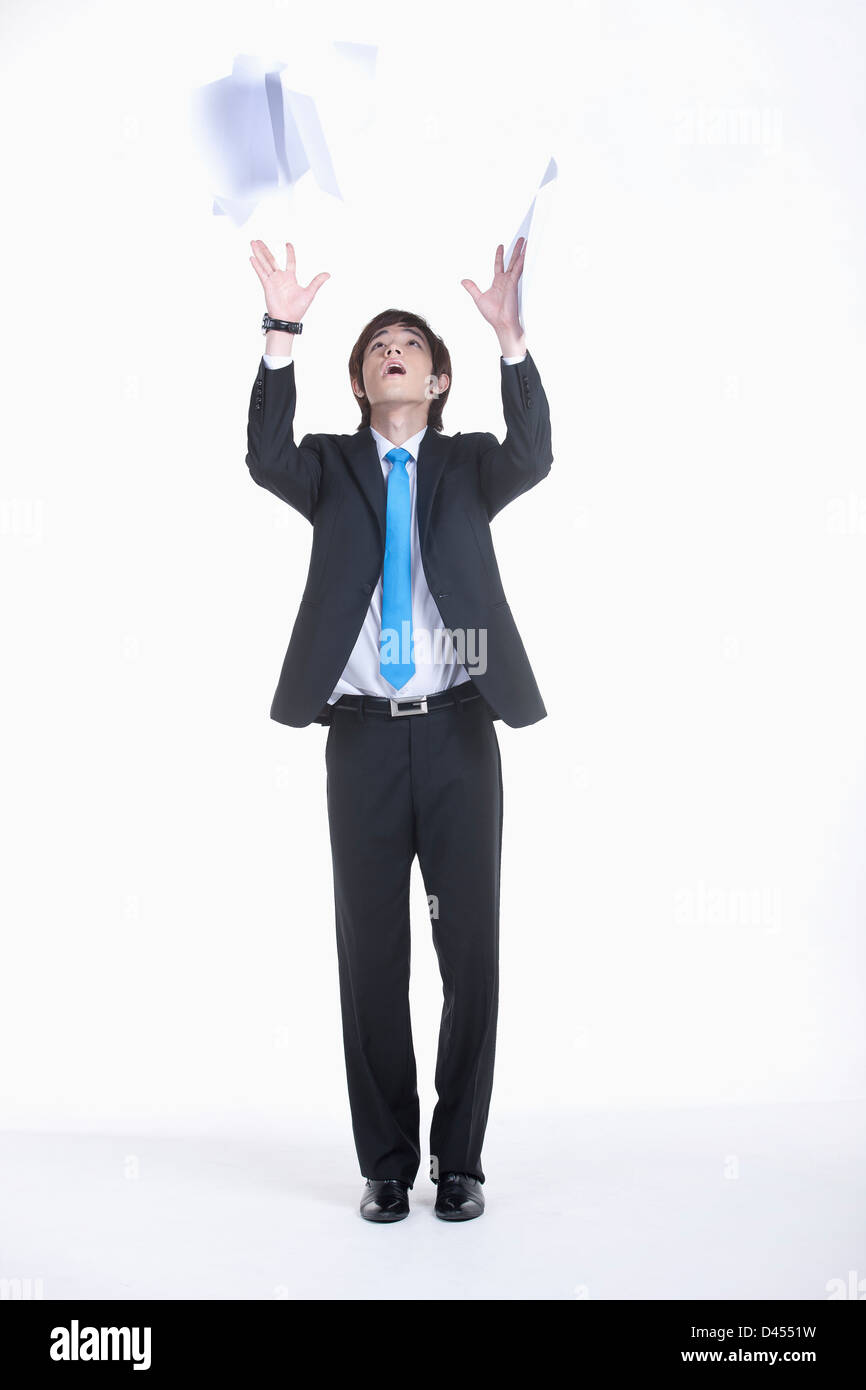 a businessman throwing papers in the air Stock Photo - Alamy