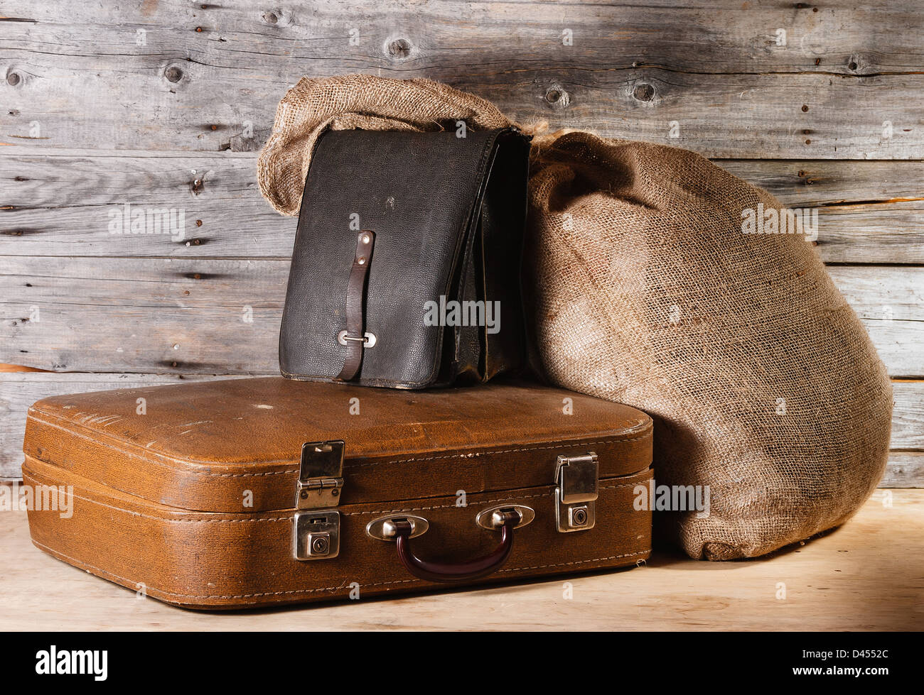 Luggage - ancient suitcase, leather bag and burlap sack Stock Photo - Alamy