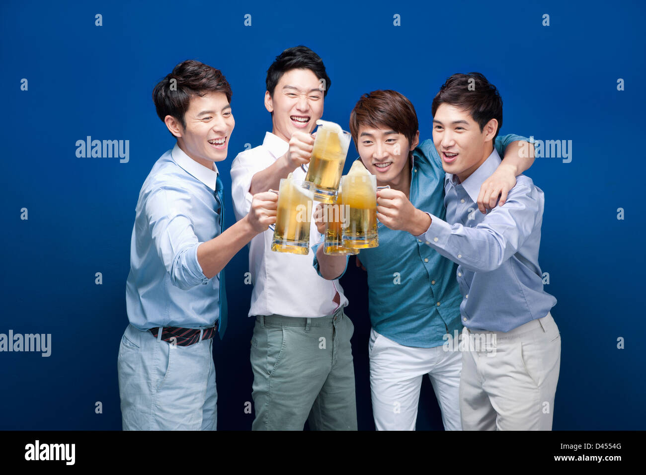 businessmen toasting with beer in a line Stock Photo - Alamy