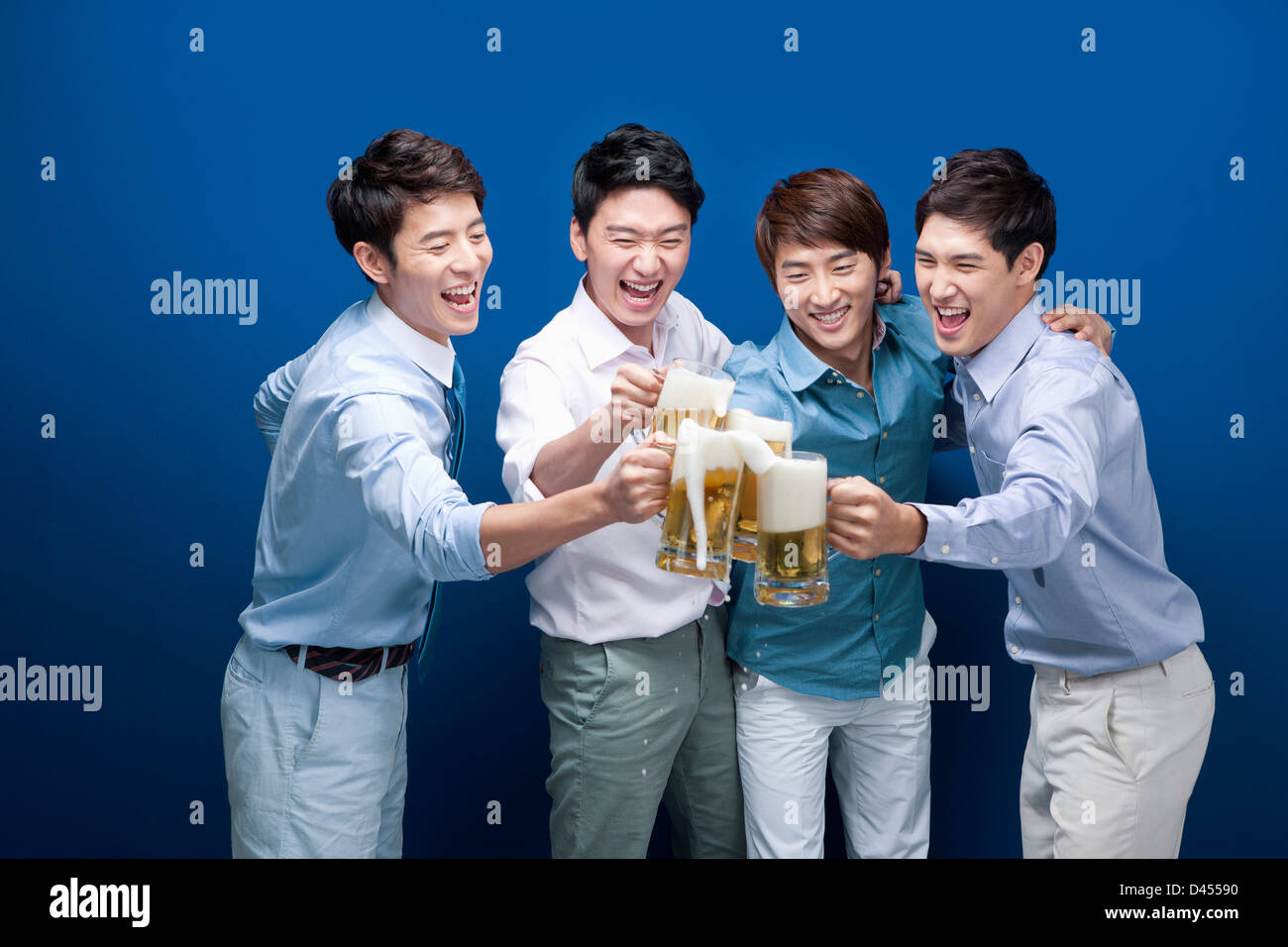 businessmen toasting with beer in a line Stock Photo - Alamy