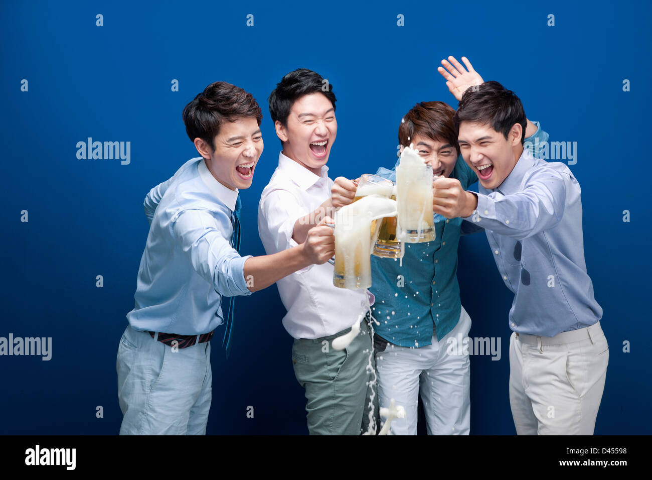 businessmen toasting with beer in a line Stock Photo - Alamy