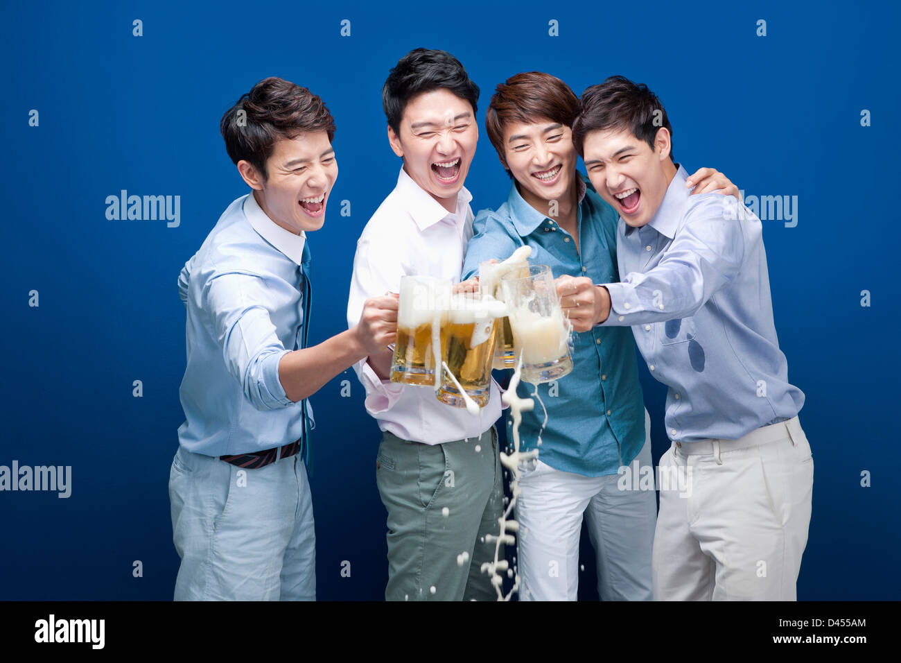 businessmen toasting with beer in a line Stock Photo - Alamy