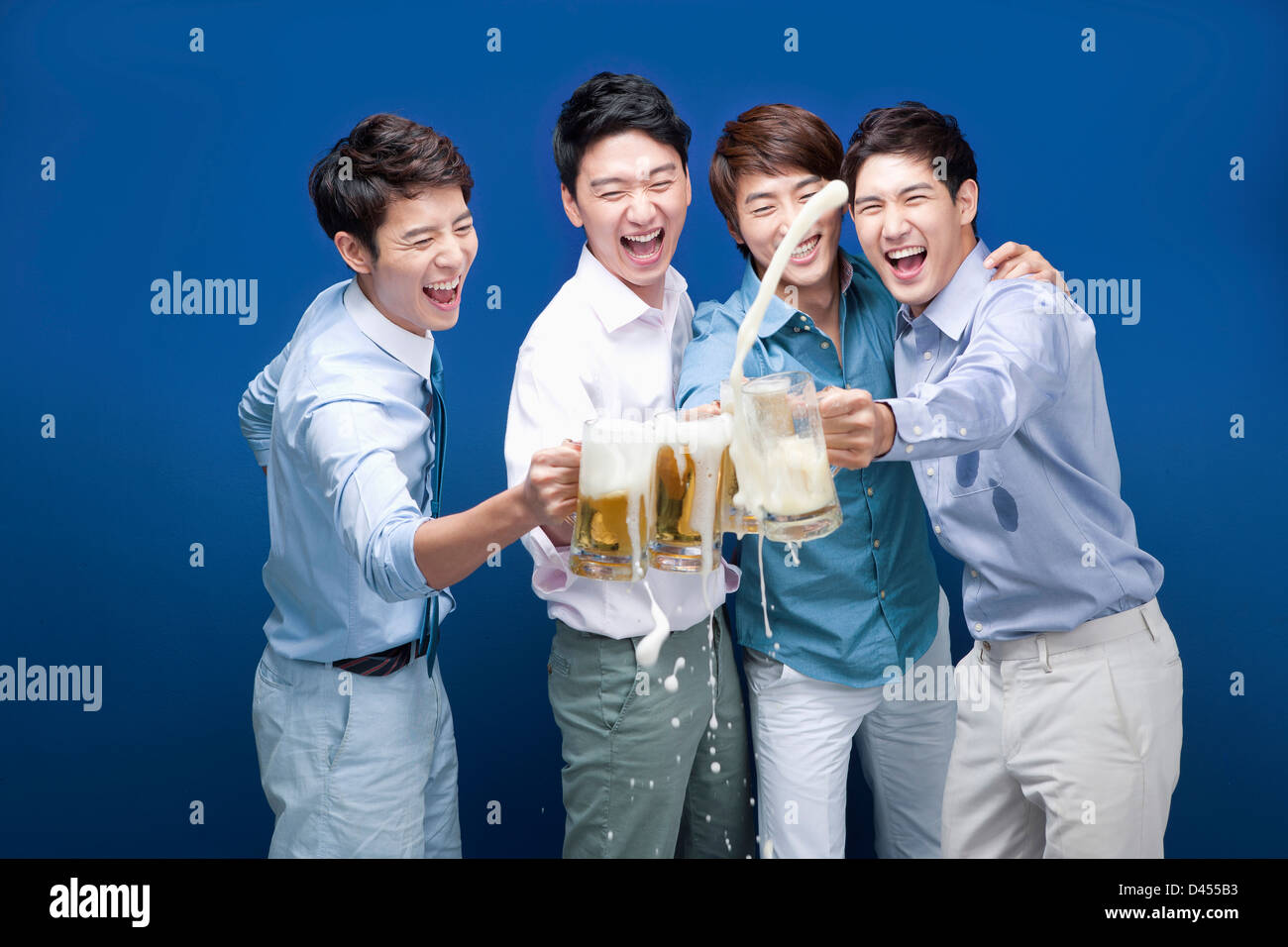 businessmen toasting with beer in a line Stock Photo - Alamy