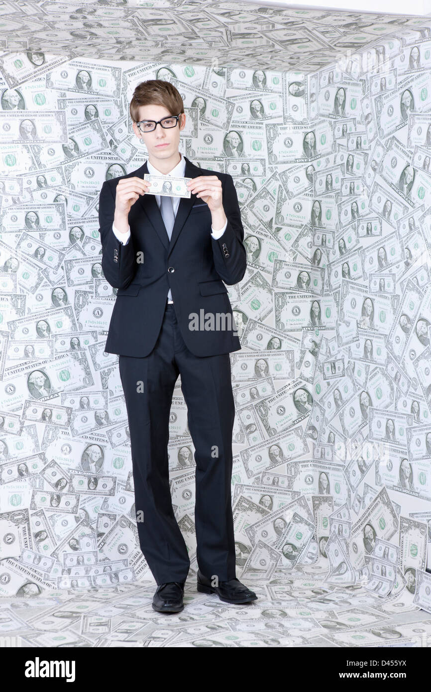 a businessman posing with dollar in a dollar room Stock Photo - Alamy