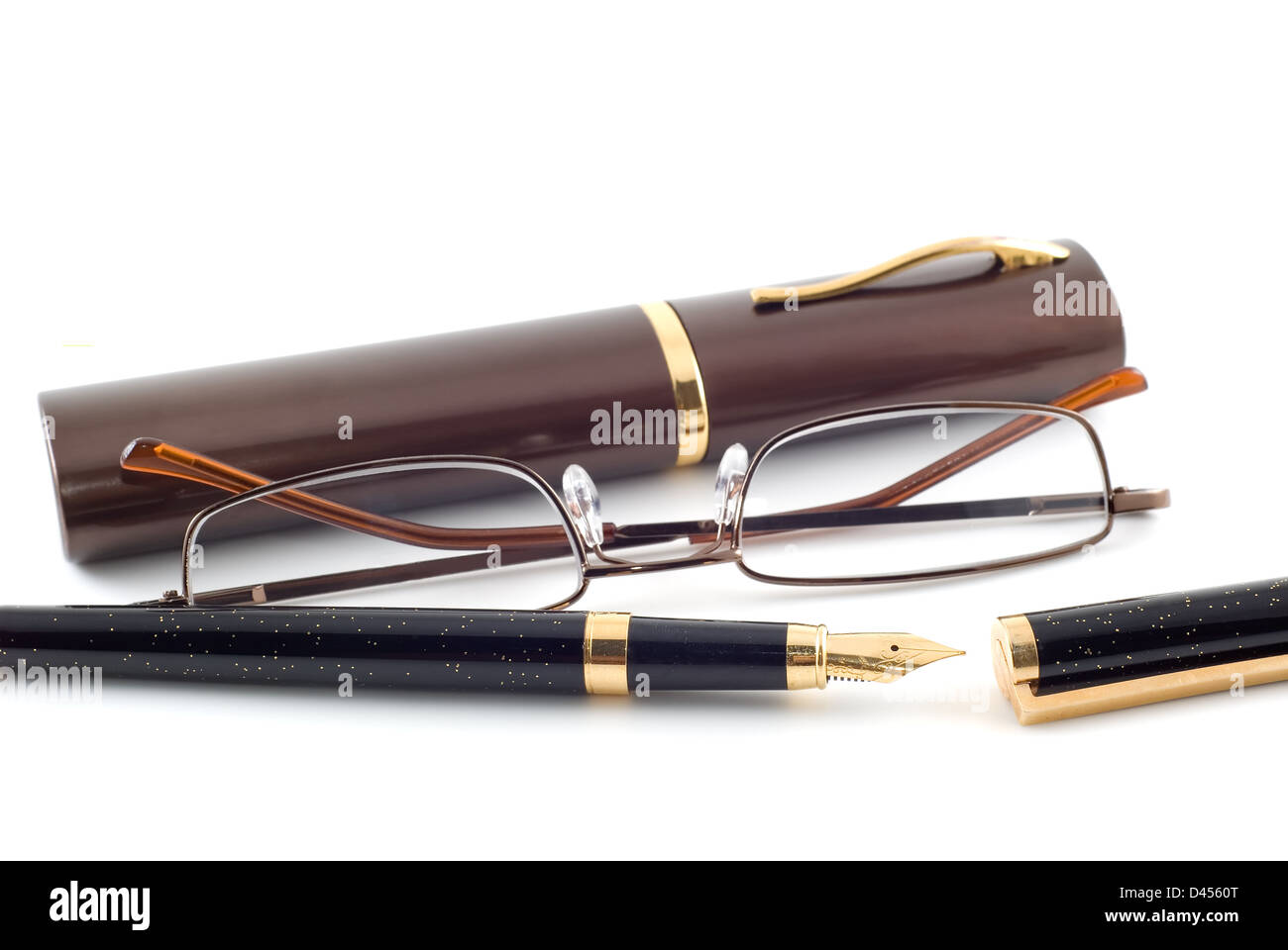 Spectacles, spectacle-case and pen are photographed on the white ...