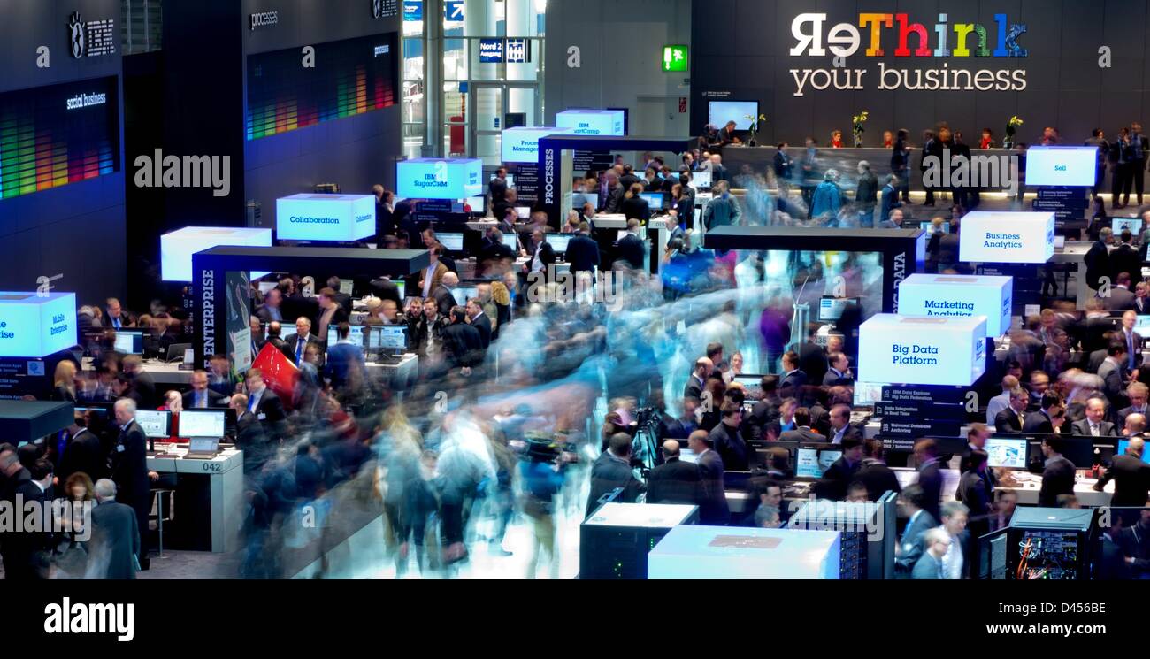 Expo visitors walk through the booths of IBM at the world's largest ...