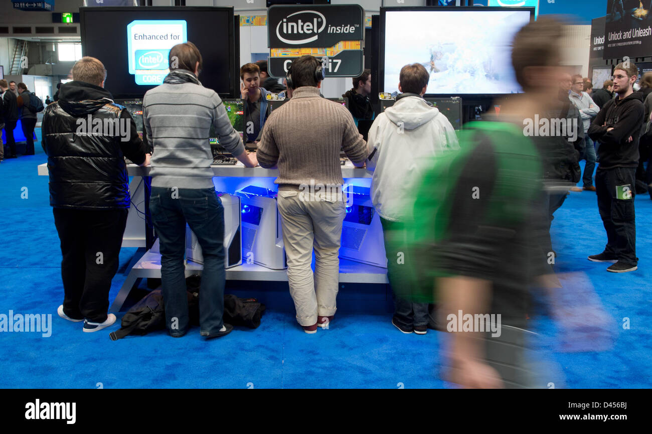 Expo visitors play computer games at the booth of Intel at the world's ...