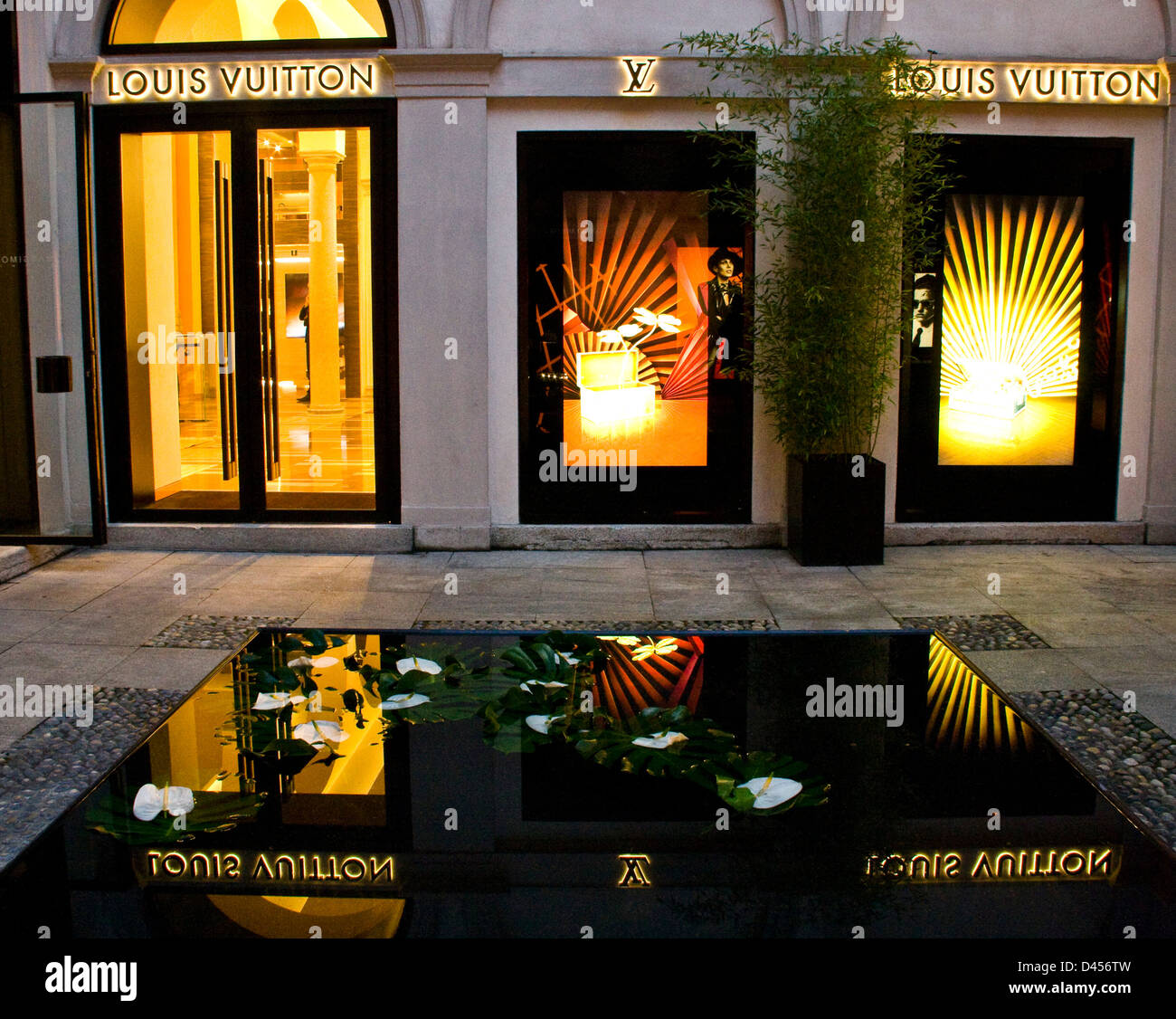 Louis Vuitton designer boutique illuminated window display with ...